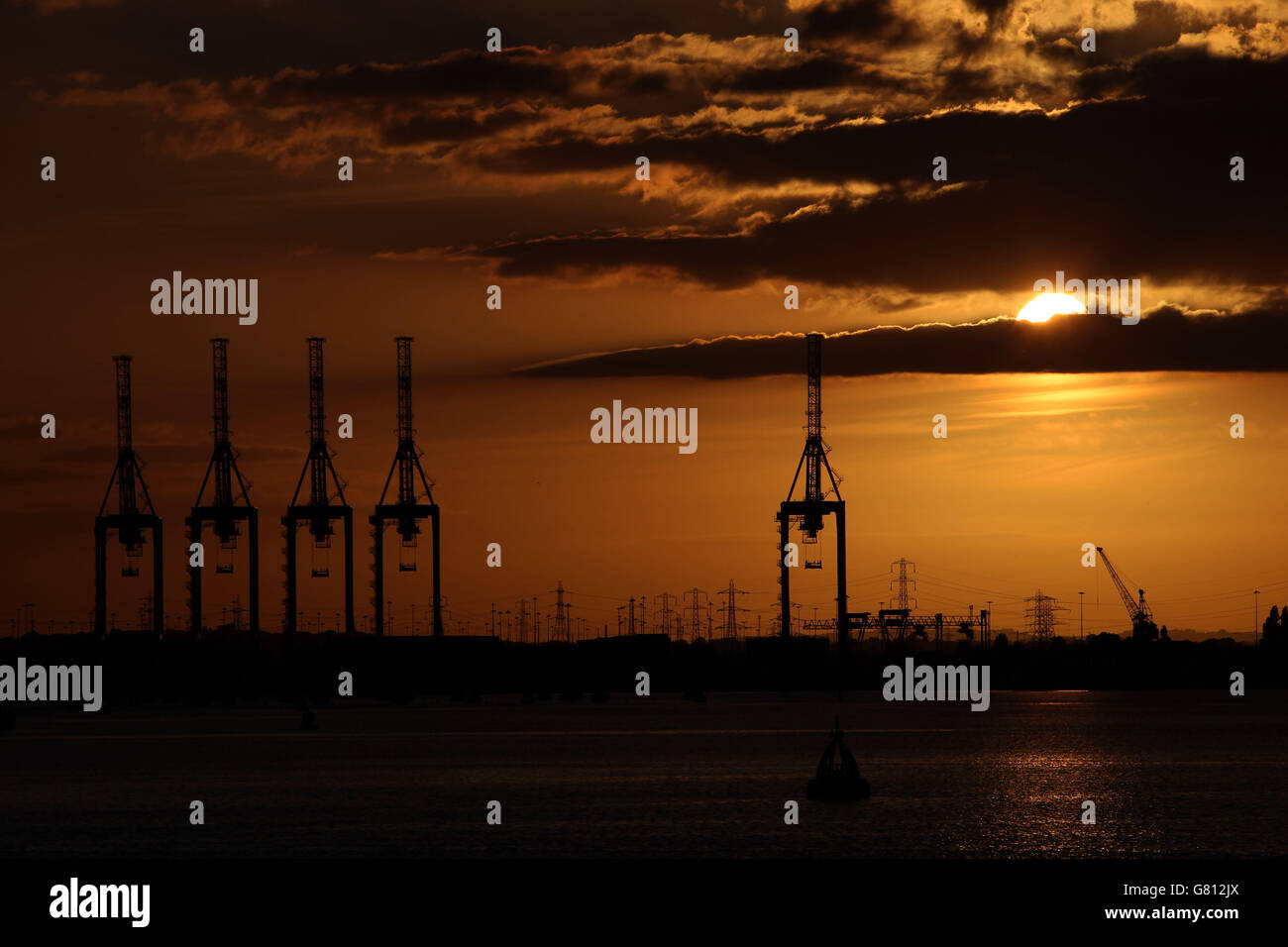 Summer Weather, Southampton. The sun sets behind dock cranes in ...