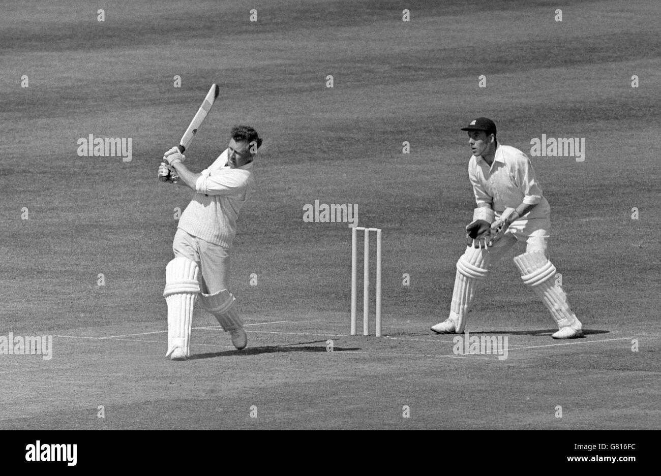 Sussex's Ken Suttle (l) drives, watched by Middlesex wicketkeeper John ...