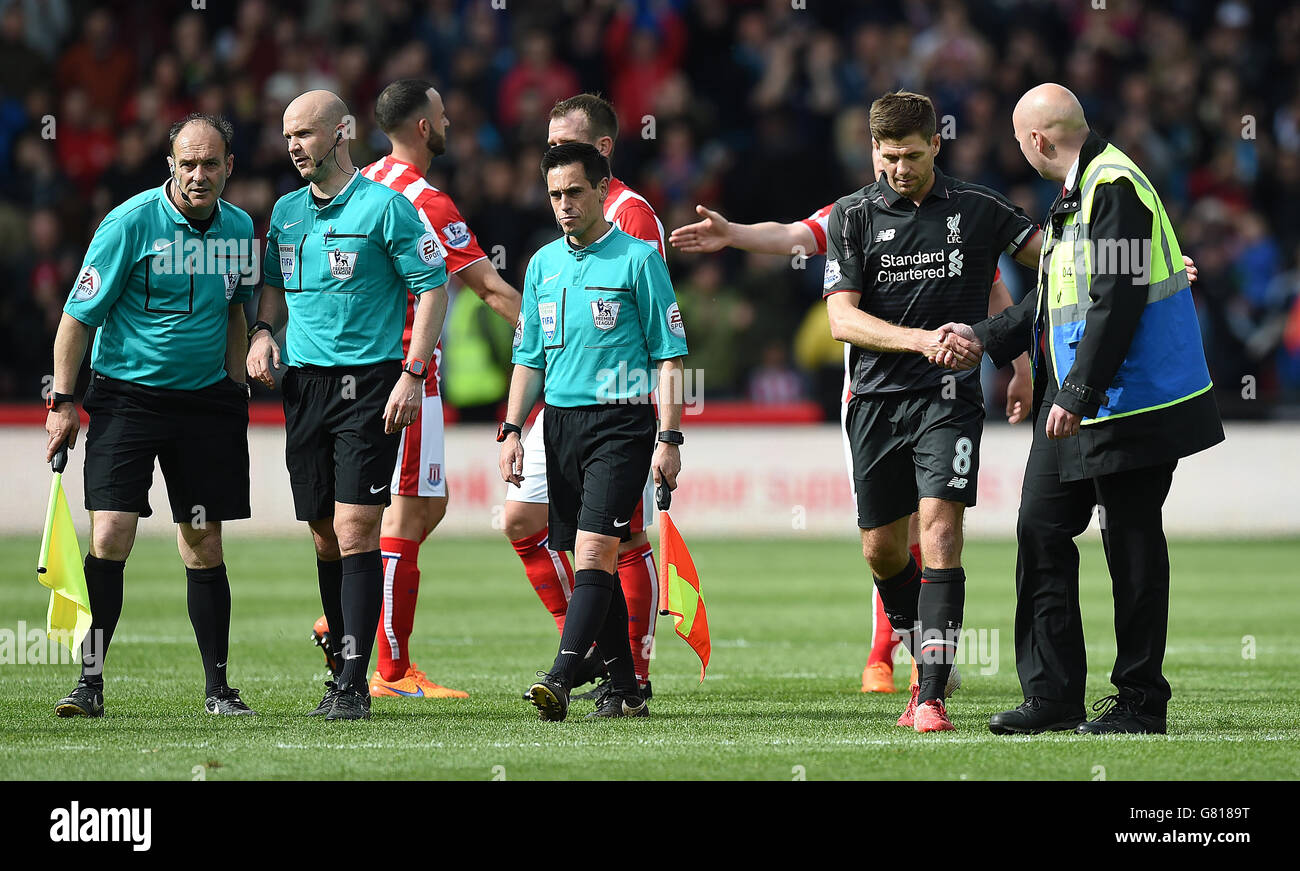 Liverpool's Steven Gerrard has his hand shaken by one of the stadium ...