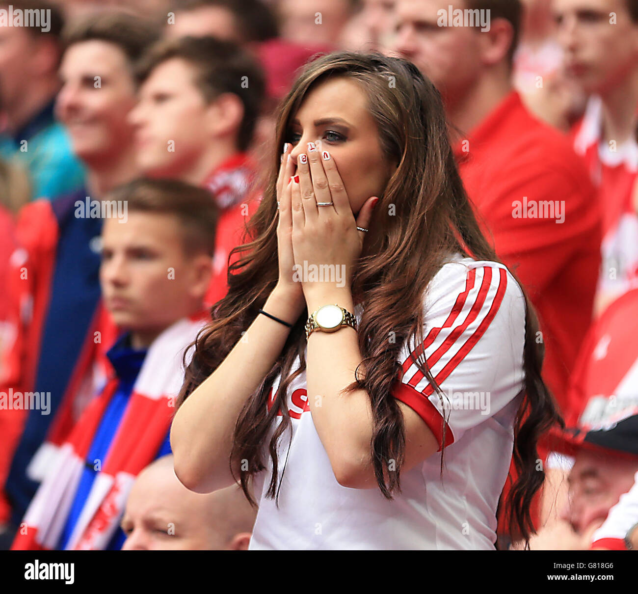A Middlesbrough fan looks dejected as they see their side concede a ...