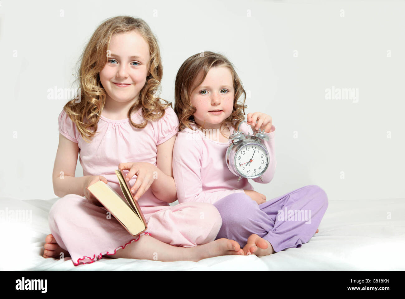 kids bedtime routine, story book and alarm clock Stock Photo - Alamy