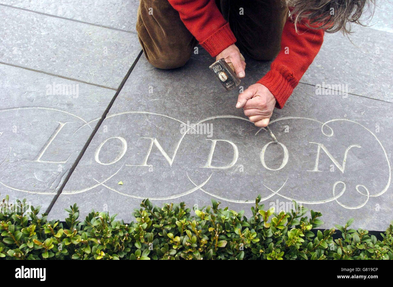 British artist and sculptor Simon Verity demonstrating his stone ...