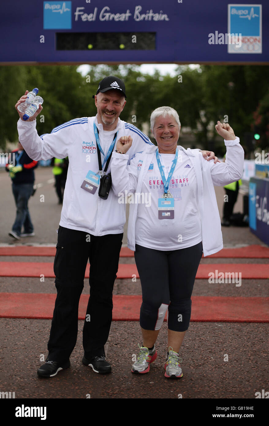 Brian Webber with his wife Hilary celebrate after crossing the finish ...
