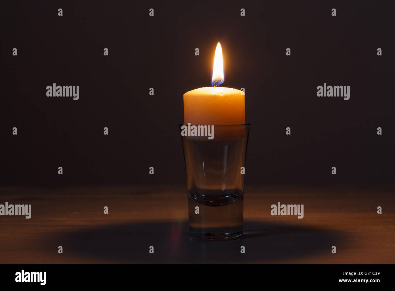 Candle lit in a transparent glass jar Stock Photo - Alamy