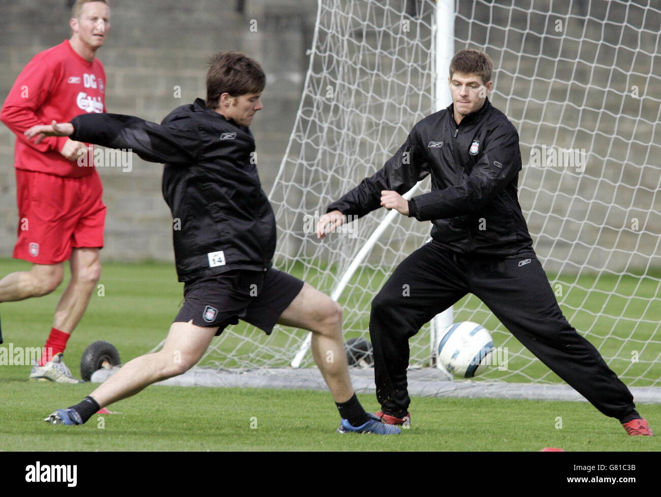 Liverpool's Steven Gerrard (R) is challenged by team mate Xabi Alonso ...