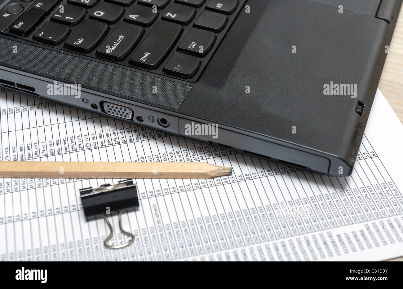 Using laptop for bussines figures, data sheet Stock Photo - Alamy