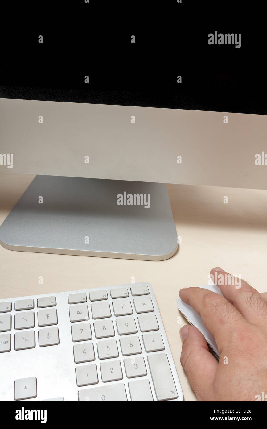 Using desktop computer for bussines figures, data sheet Stock Photo - Alamy