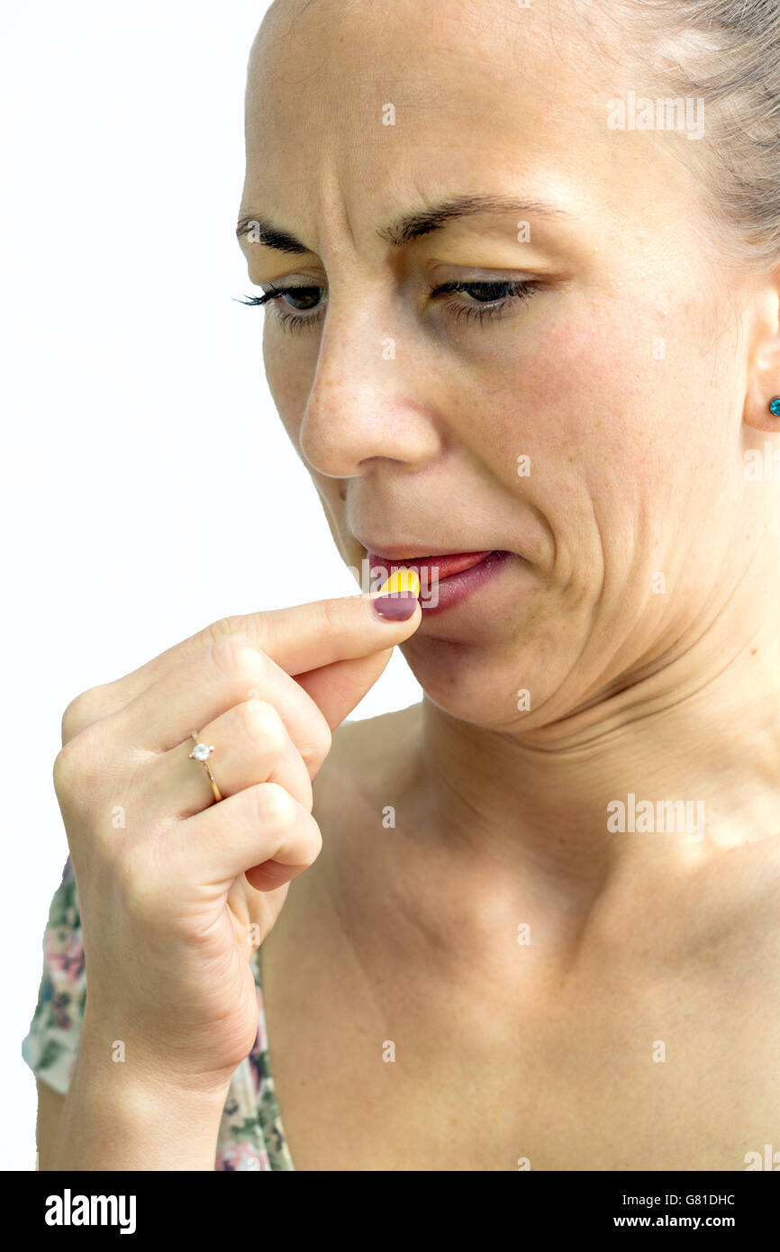 Young women taking pills against various diissease Stock Photo - Alamy
