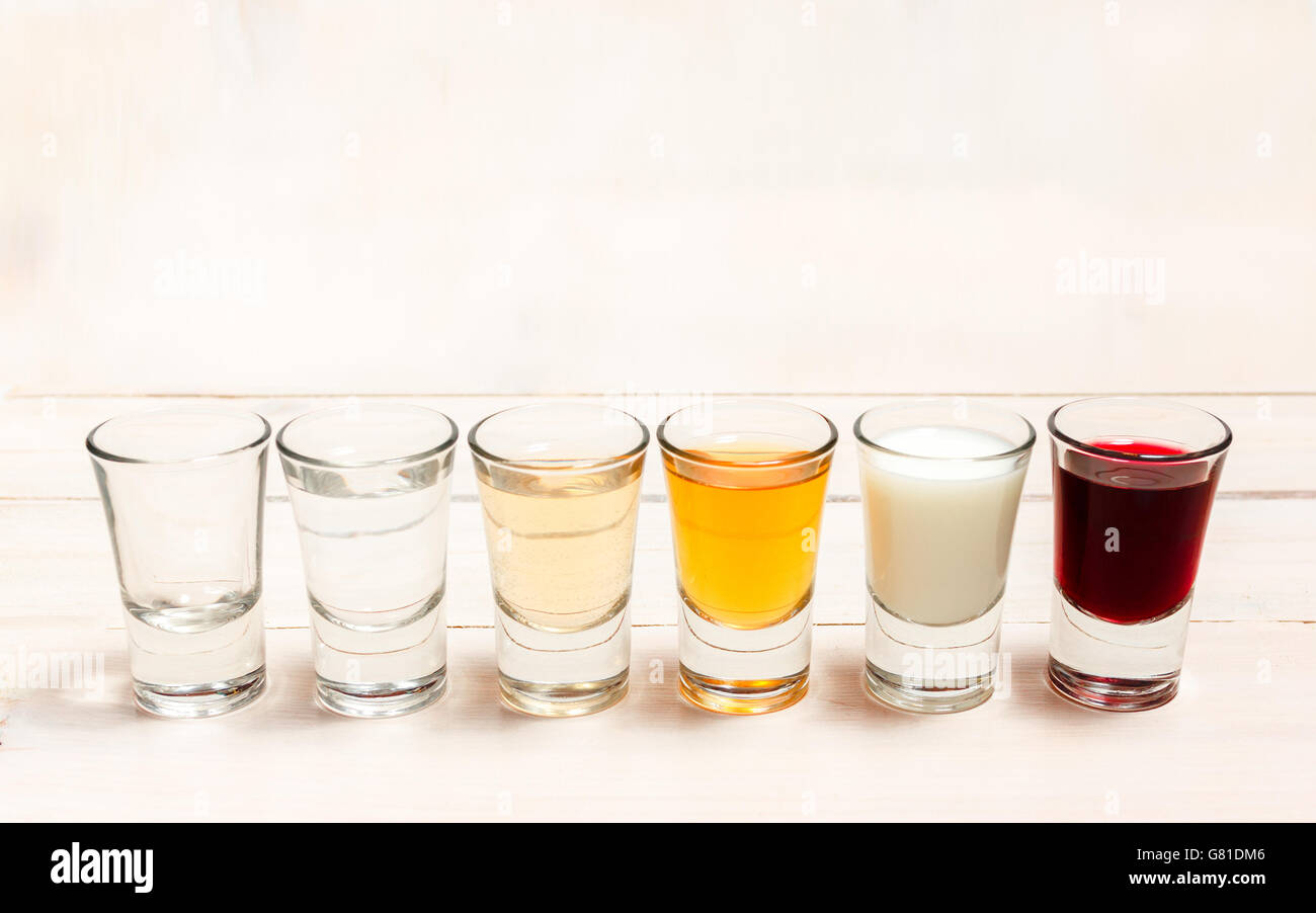 Bunch of shots, filled with water, apple juice, wine, sparkling and ...