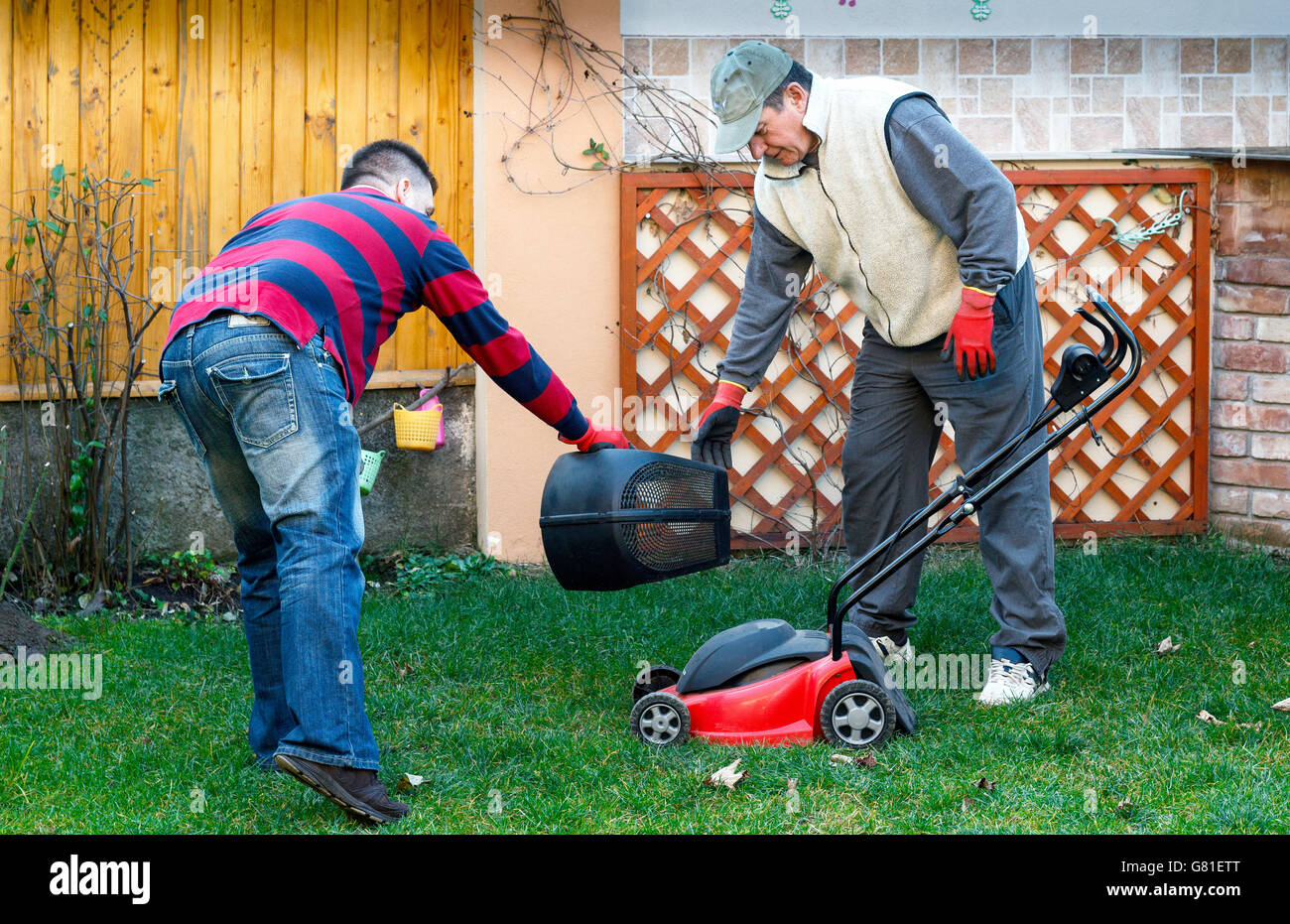 Younger man helping senior man is gardening, household activity Stock ...