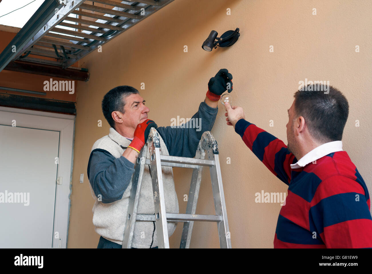 Younger man helping senior man is gardening, household activity Stock ...