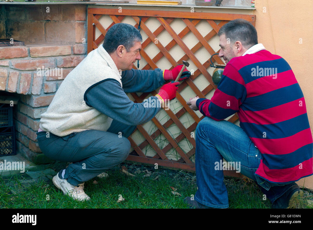 Younger man helping senior man is gardening, household activity Stock ...
