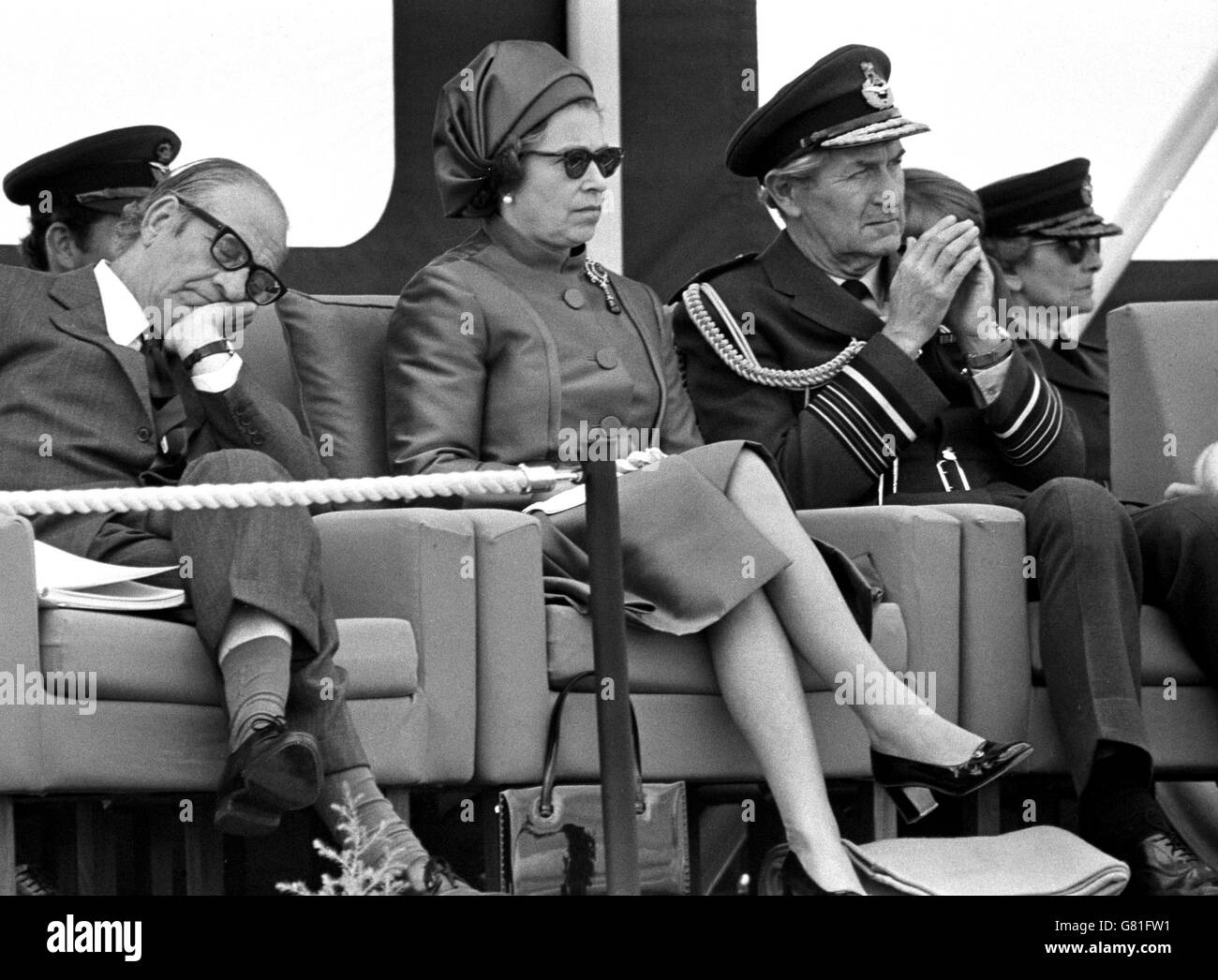 Queen Elizabeth II, centre, looks on as Defence Minister Fred Mulley ...