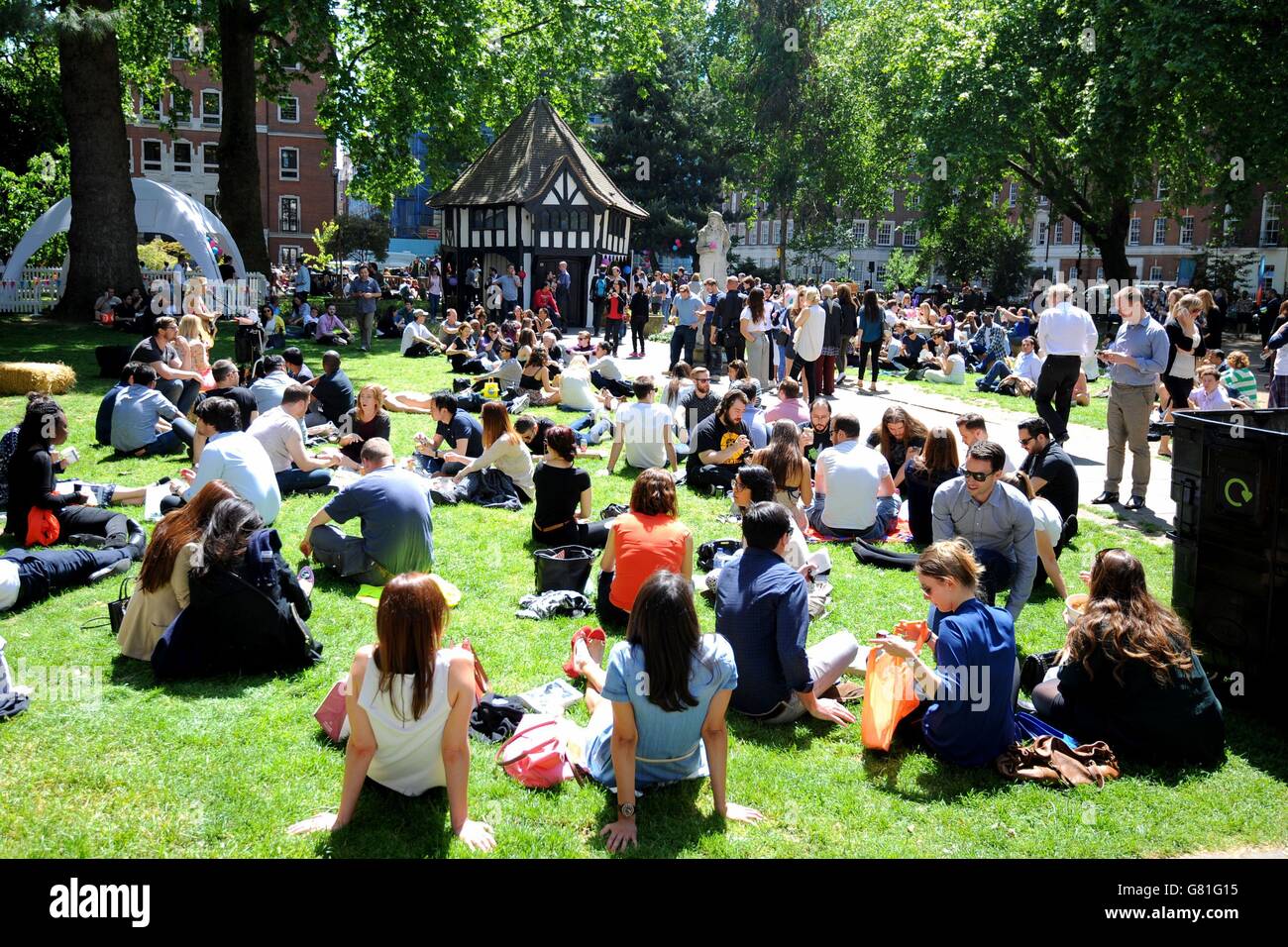 People enjoy the sun in Soho Square as temperatures reached 22 degrees ...