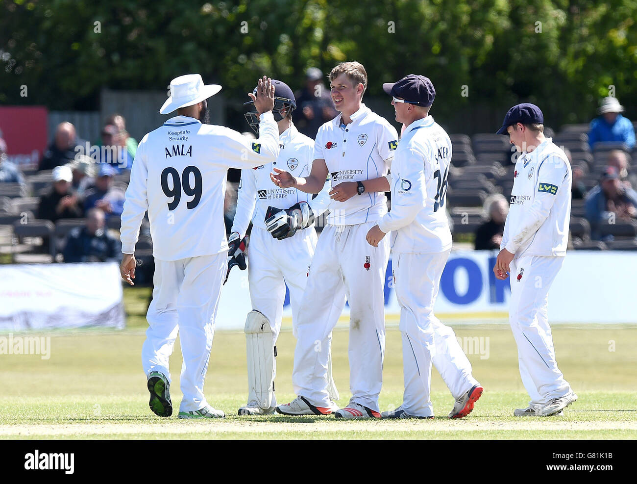 Derbyshire's Matthew Critchley (centre) celebrates taking the wicket of ...