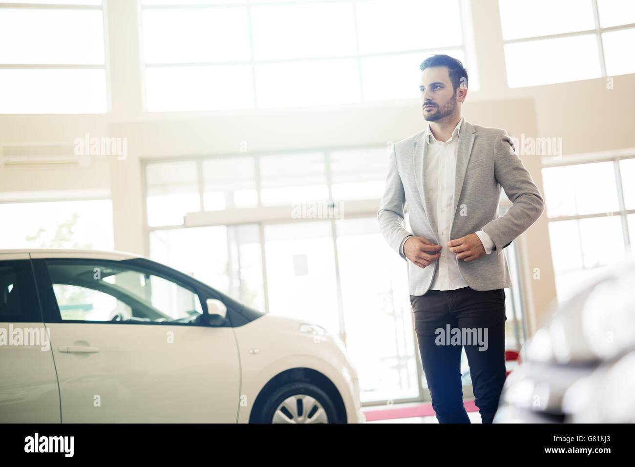 Customer walks into car dealership to buy a new car Stock Photo - Alamy