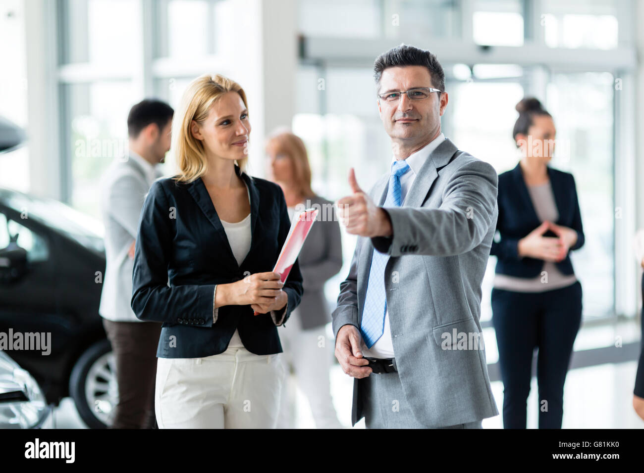 Professional salesperson working in car dealership Stock Photo - Alamy