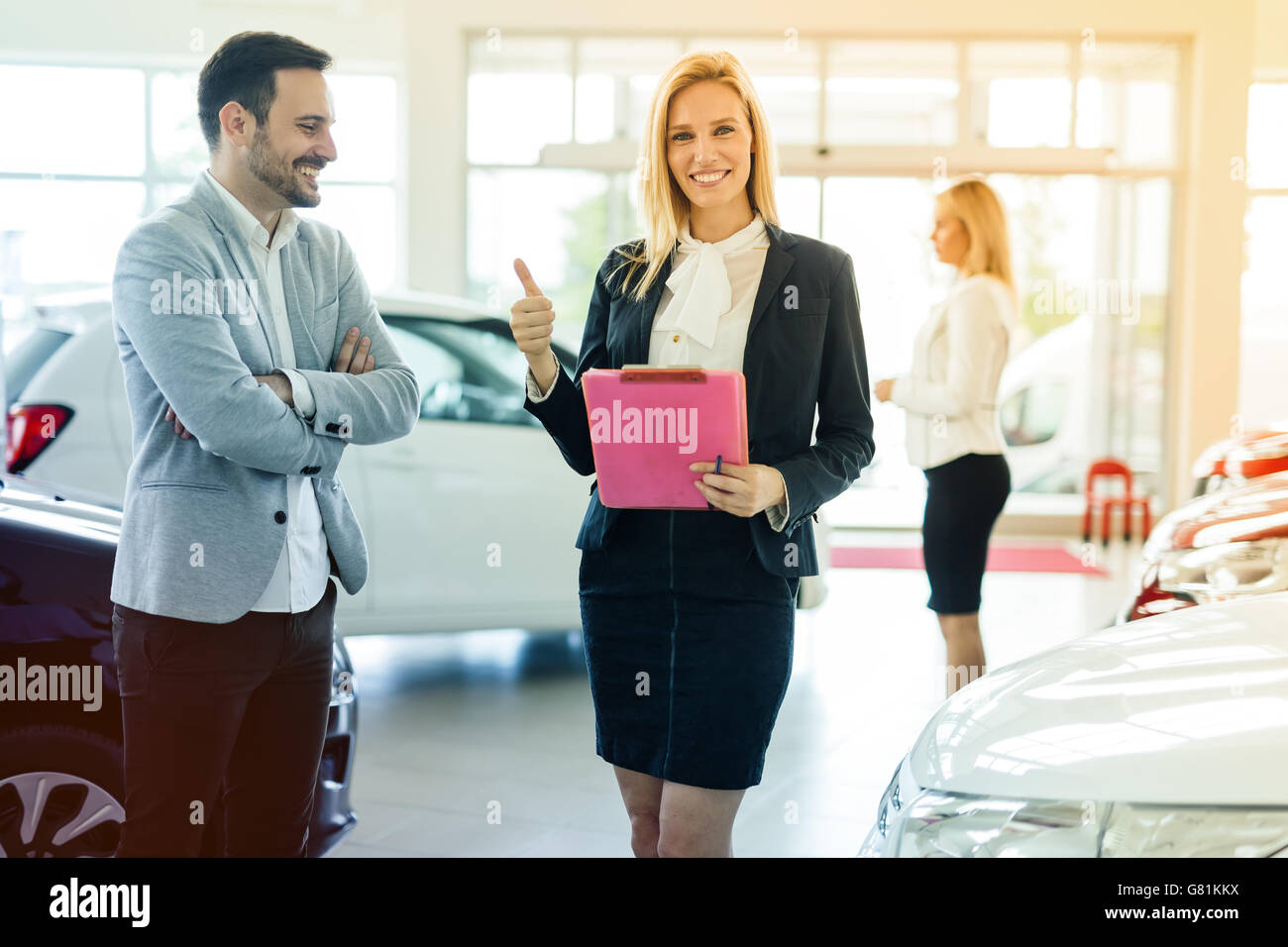 Customer looking for a car at dealership and customizing vehicle Stock ...