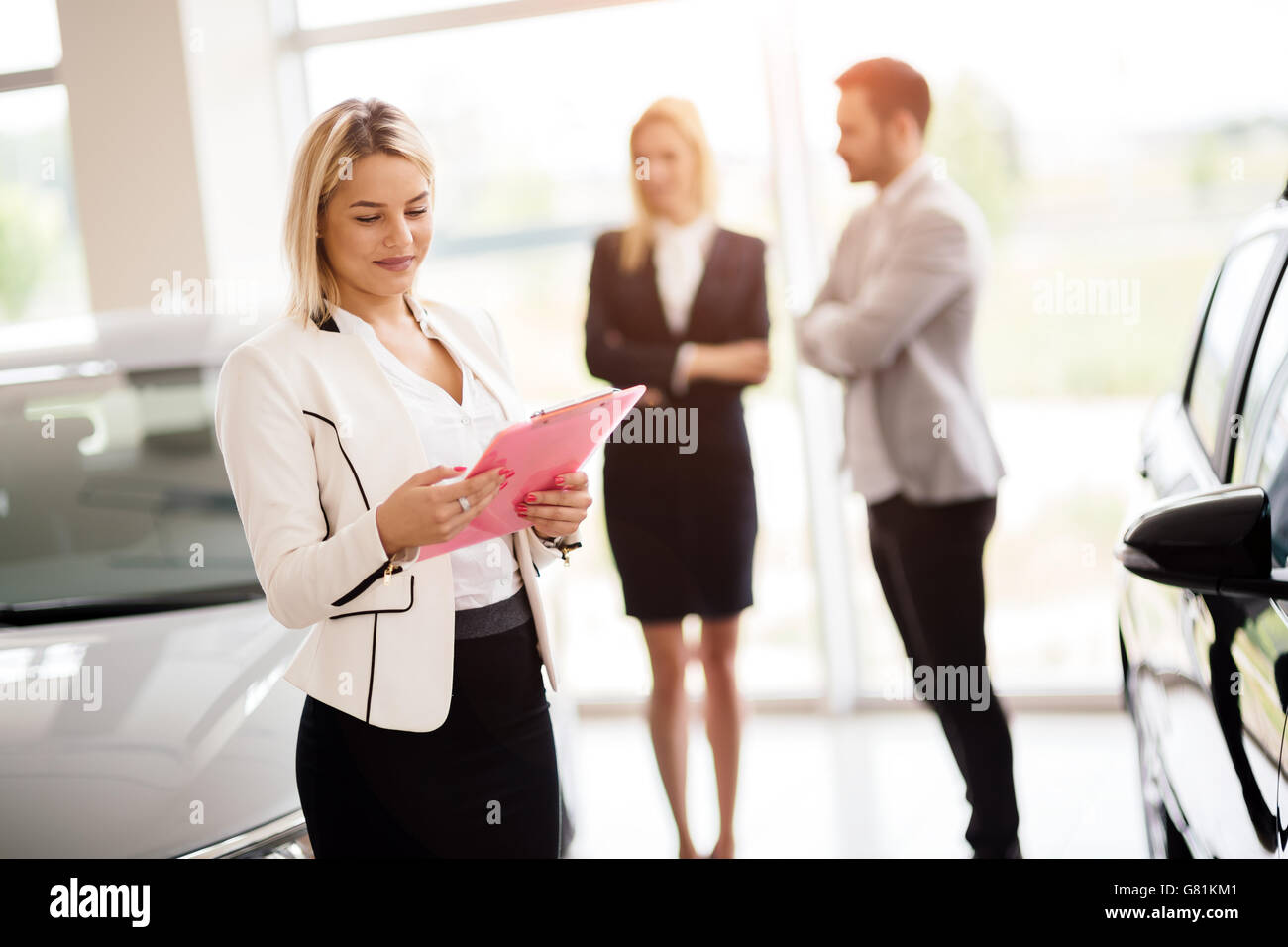 Customer looking for a car at dealership and customizing vehicle Stock ...