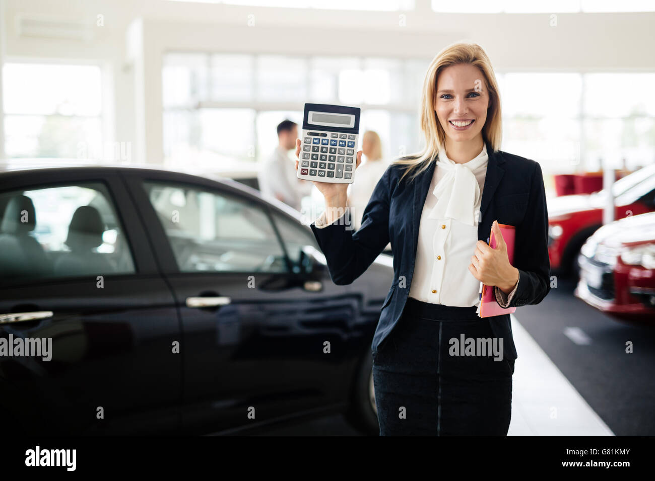 Professional salesperson working in car dealership Stock Photo - Alamy