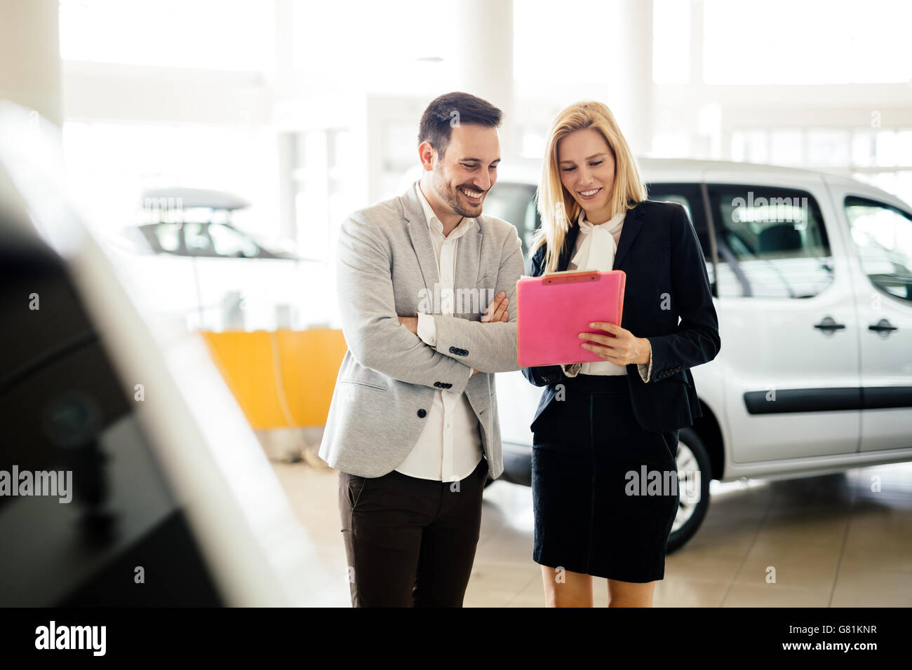 Customer looking for a car at dealership and customizing vehicle Stock ...