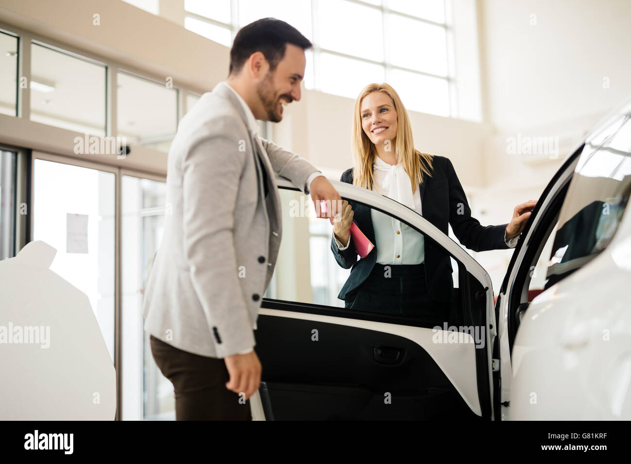 Male car salesperson explaining vehicle hi-res stock photography and ...