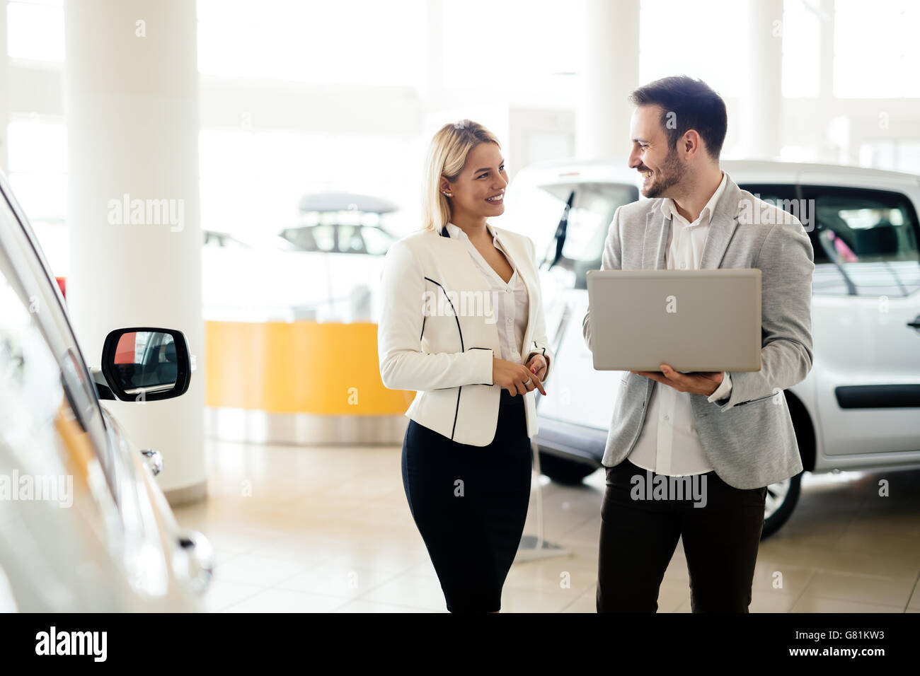 Customer looking for a car at dealership and customizing vehicle Stock ...