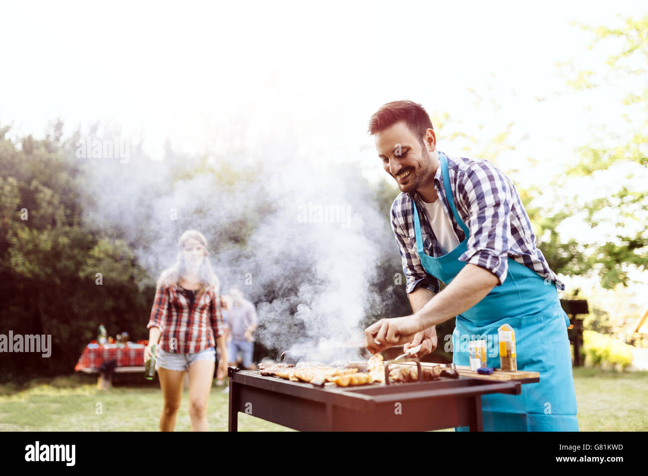 Barbecue in nature being done by friends Stock Photo - Alamy