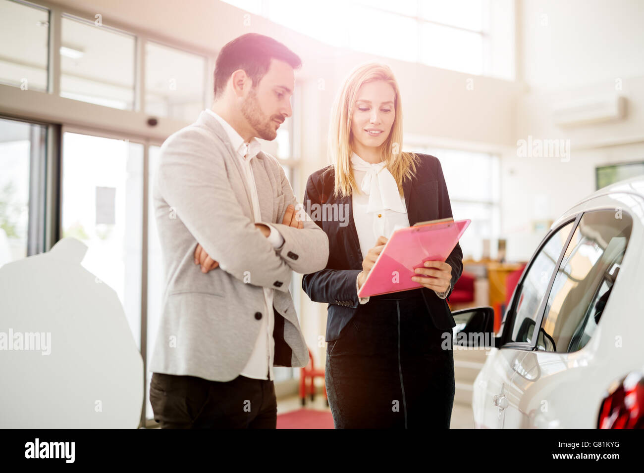 Customer looking for a car at dealership and customizing vehicle Stock ...