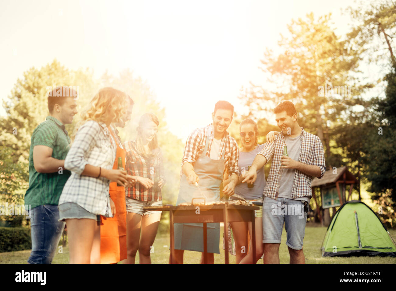 Friends having fun in nature doing bbq Stock Photo - Alamy