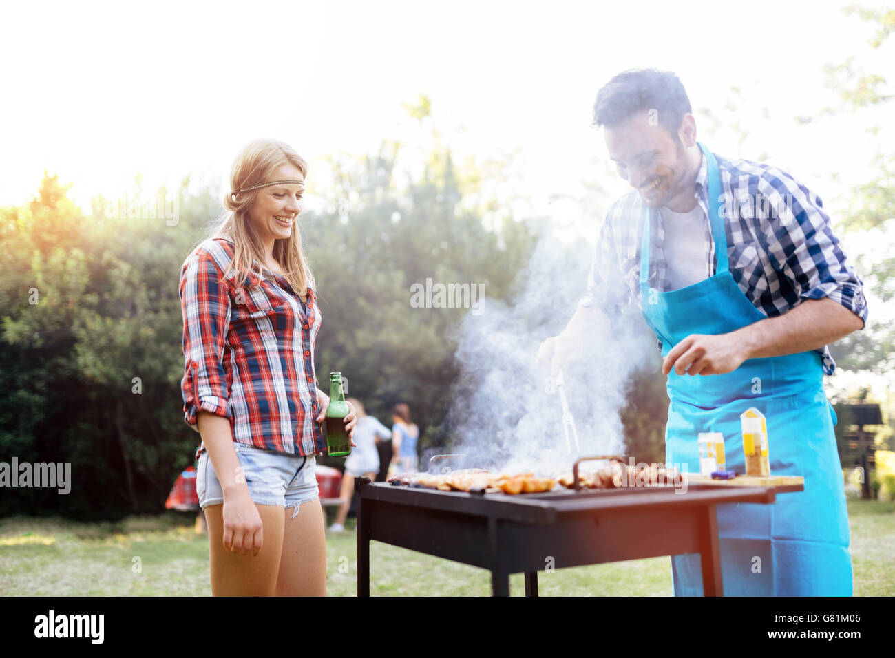 Young people barbecuing hi-res stock photography and images - Alamy