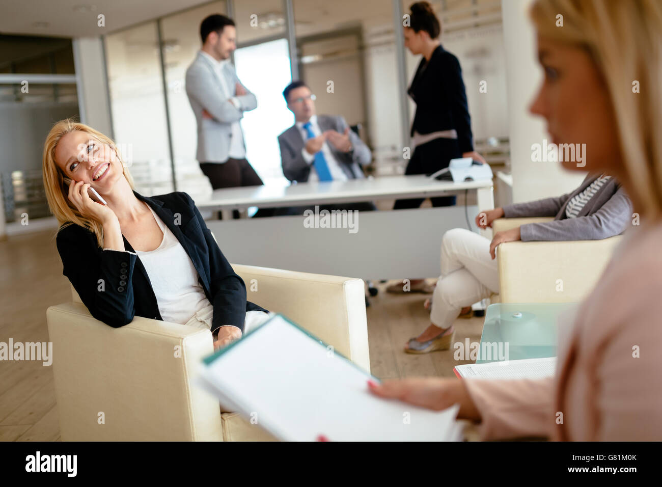 Busy businesswoman has to answer phone multiple times during work Stock ...
