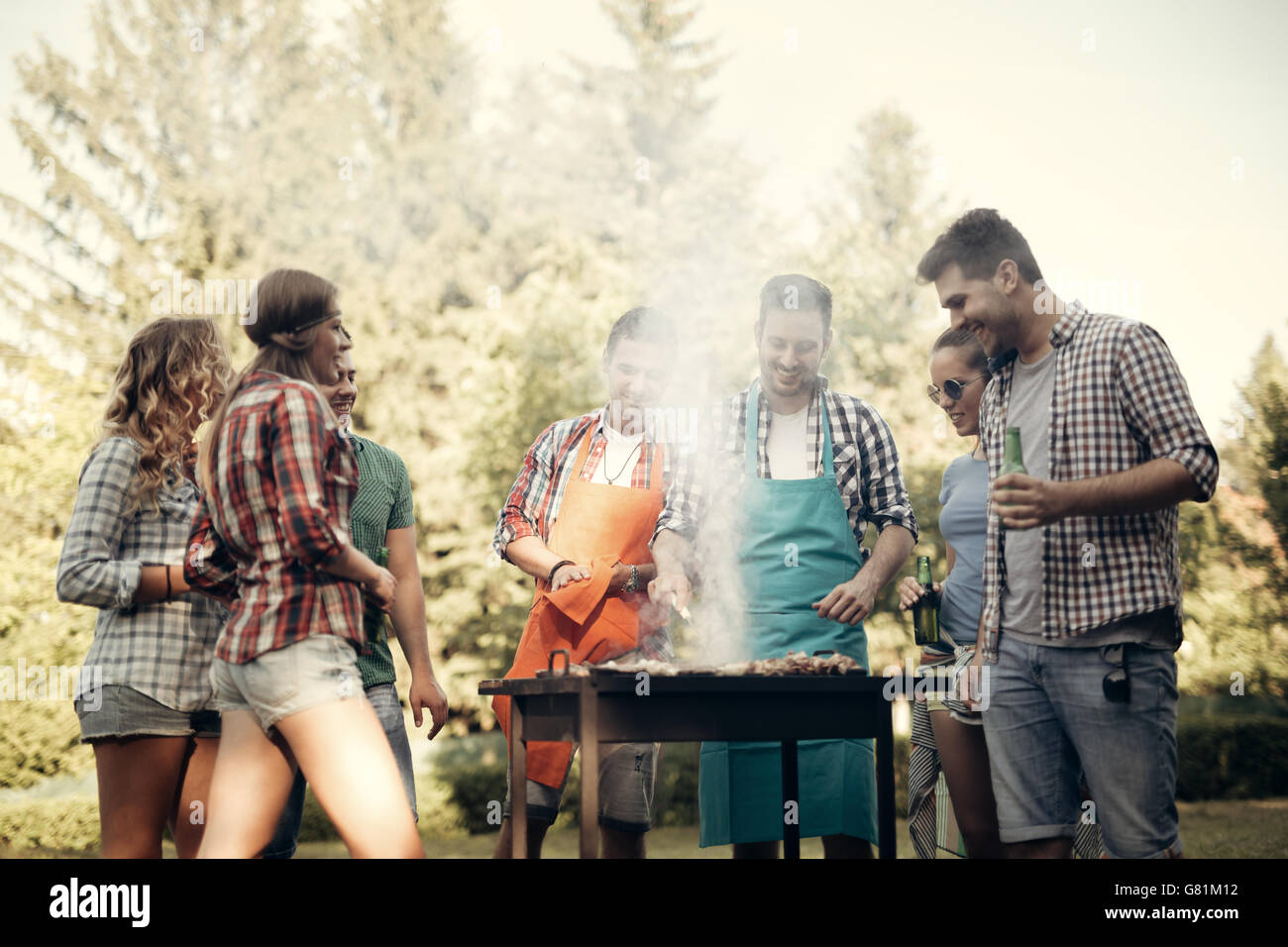 Friends having fun in nature doing bbq Stock Photo - Alamy