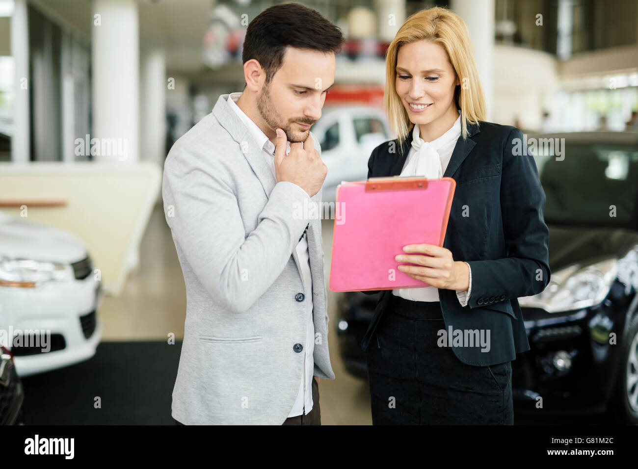 Customer looking for a car at dealership and customizing vehicle Stock ...