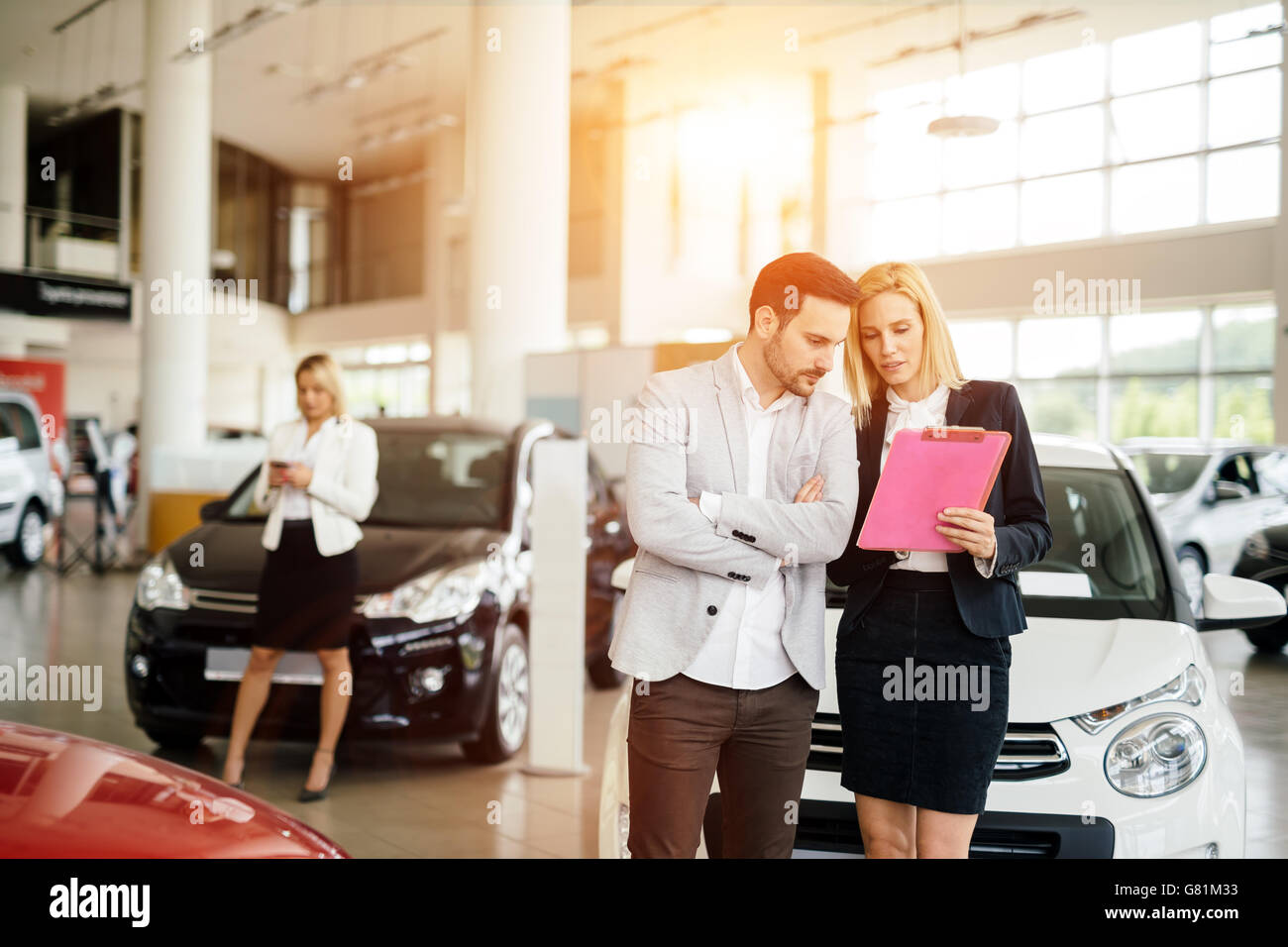 Customer looking for a car at dealership and customizing vehicle Stock ...