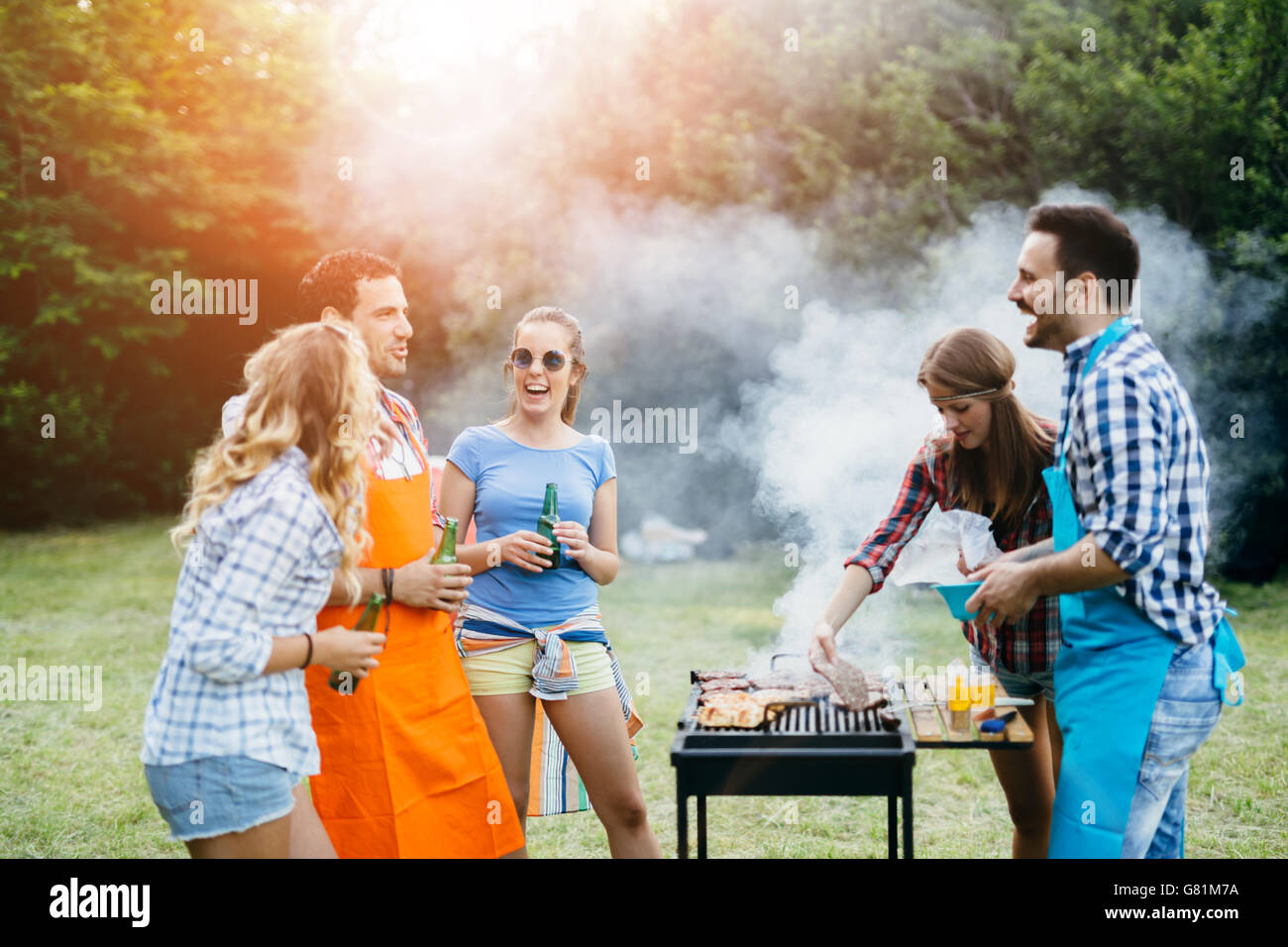Friends having fun in nature doing bbq Stock Photo - Alamy