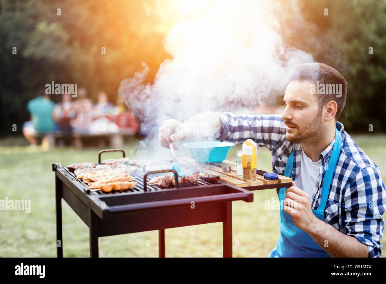 Barbecue in nature being done by friends Stock Photo - Alamy