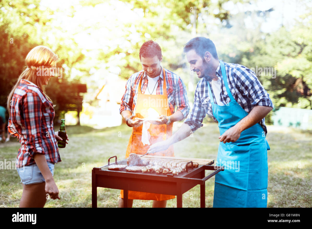 Friends having fun in nature doing bbq Stock Photo - Alamy