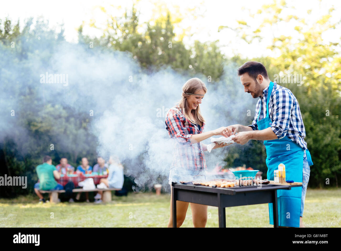 Friends having fun in nature doing bbq Stock Photo - Alamy