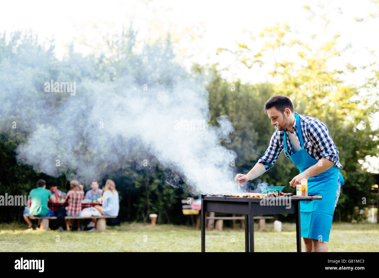 Barbecue in nature being done by friends Stock Photo - Alamy