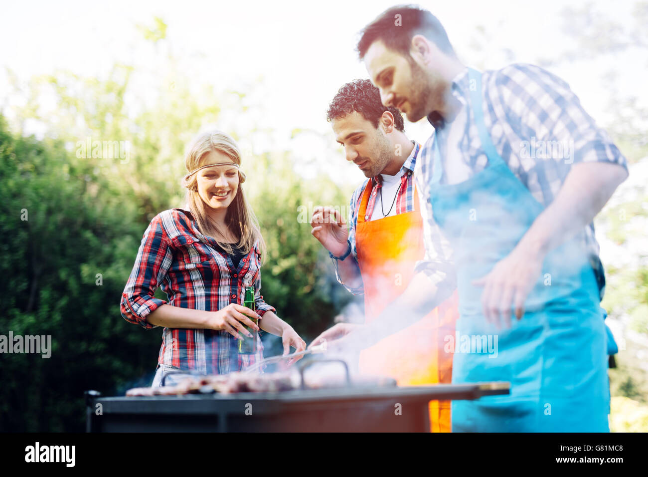 Friends having fun in nature doing bbq Stock Photo - Alamy