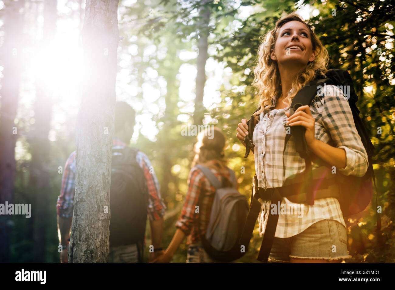 Group of people trekking in forest Stock Photo - Alamy
