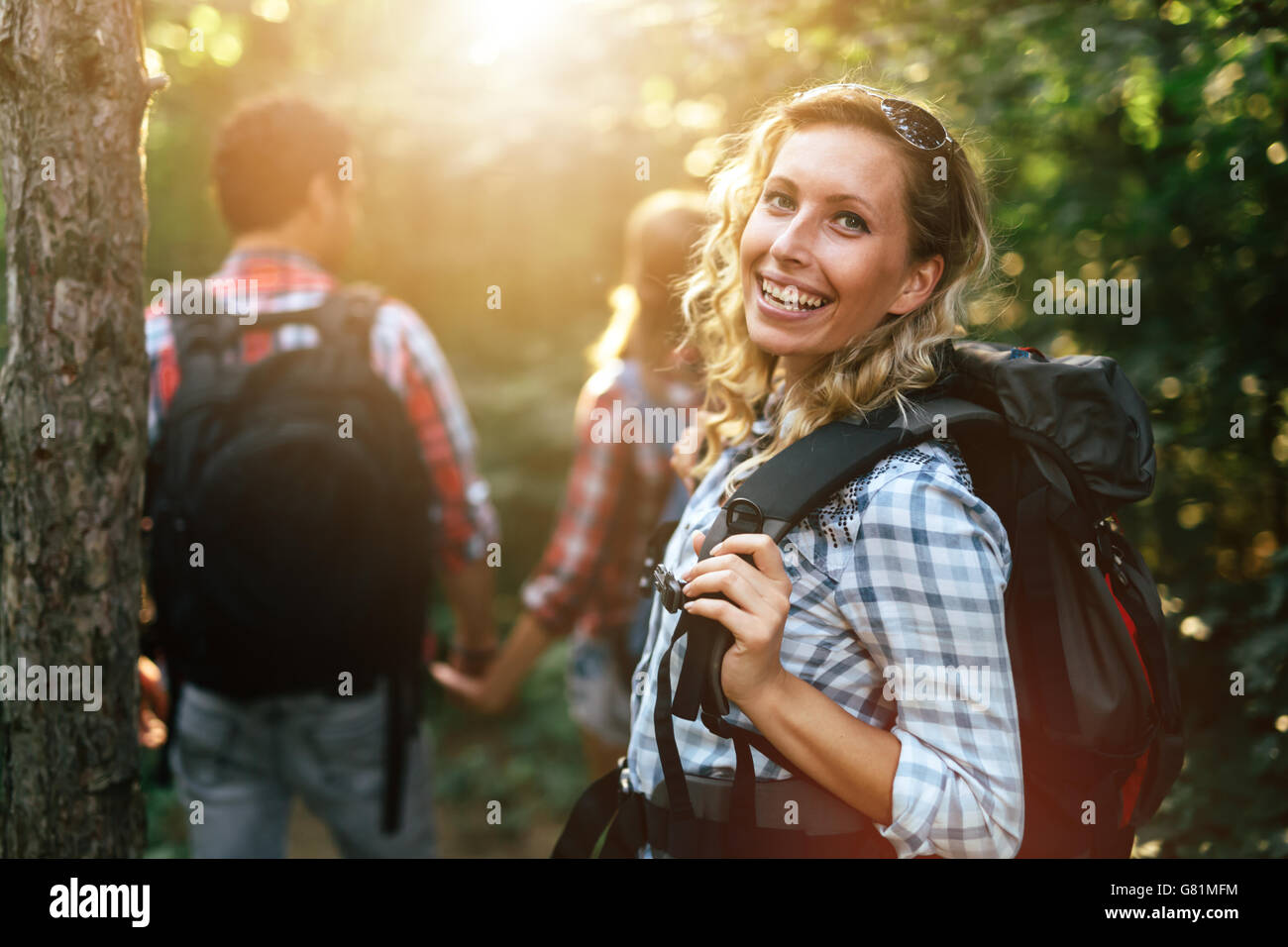 Group of people trekking in forest Stock Photo - Alamy