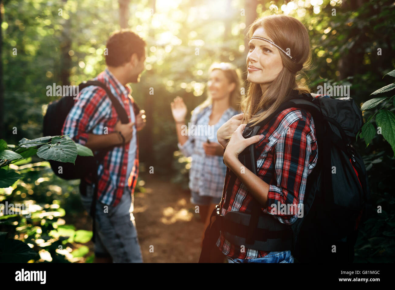 Group of people trekking in forest Stock Photo - Alamy