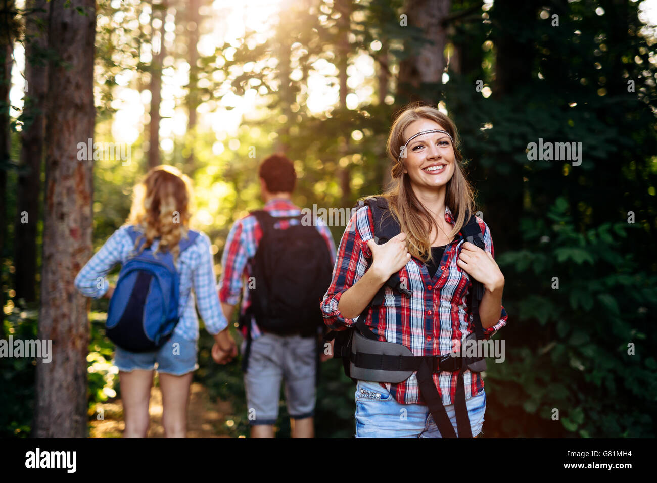 Group of people trekking in forest Stock Photo - Alamy