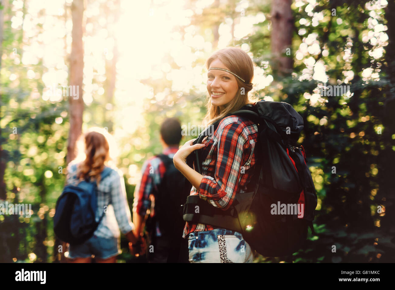Group of people trekking in forest Stock Photo - Alamy