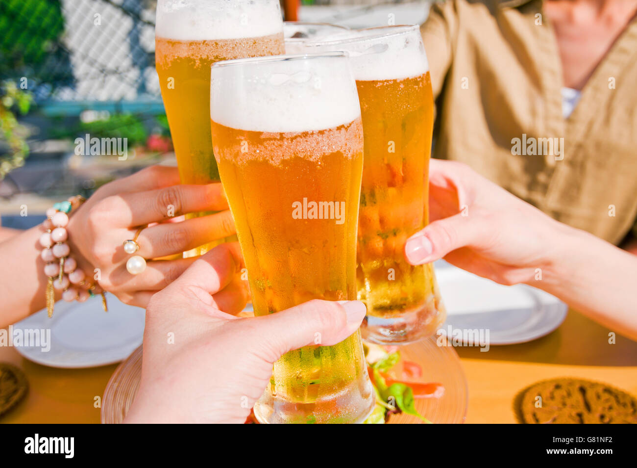 Women having a toast with beer Stock Photo - Alamy