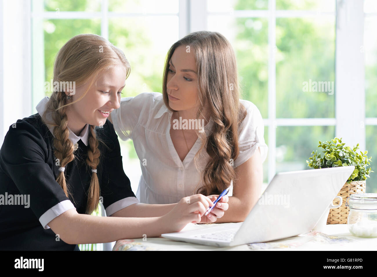 mother and daughter with laptop Stock Photo - Alamy