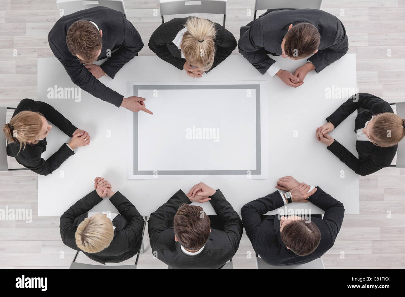 Diverse business people sitting around the table on a meeting Stock ...
