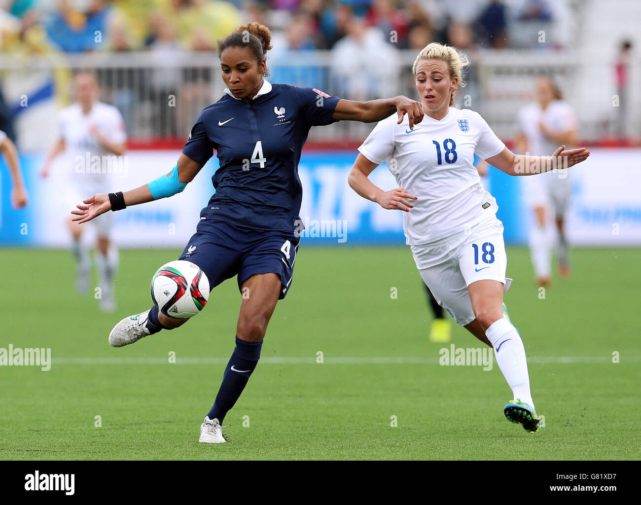 France's Laura Georges (left) clears the ball as she is under pressure ...